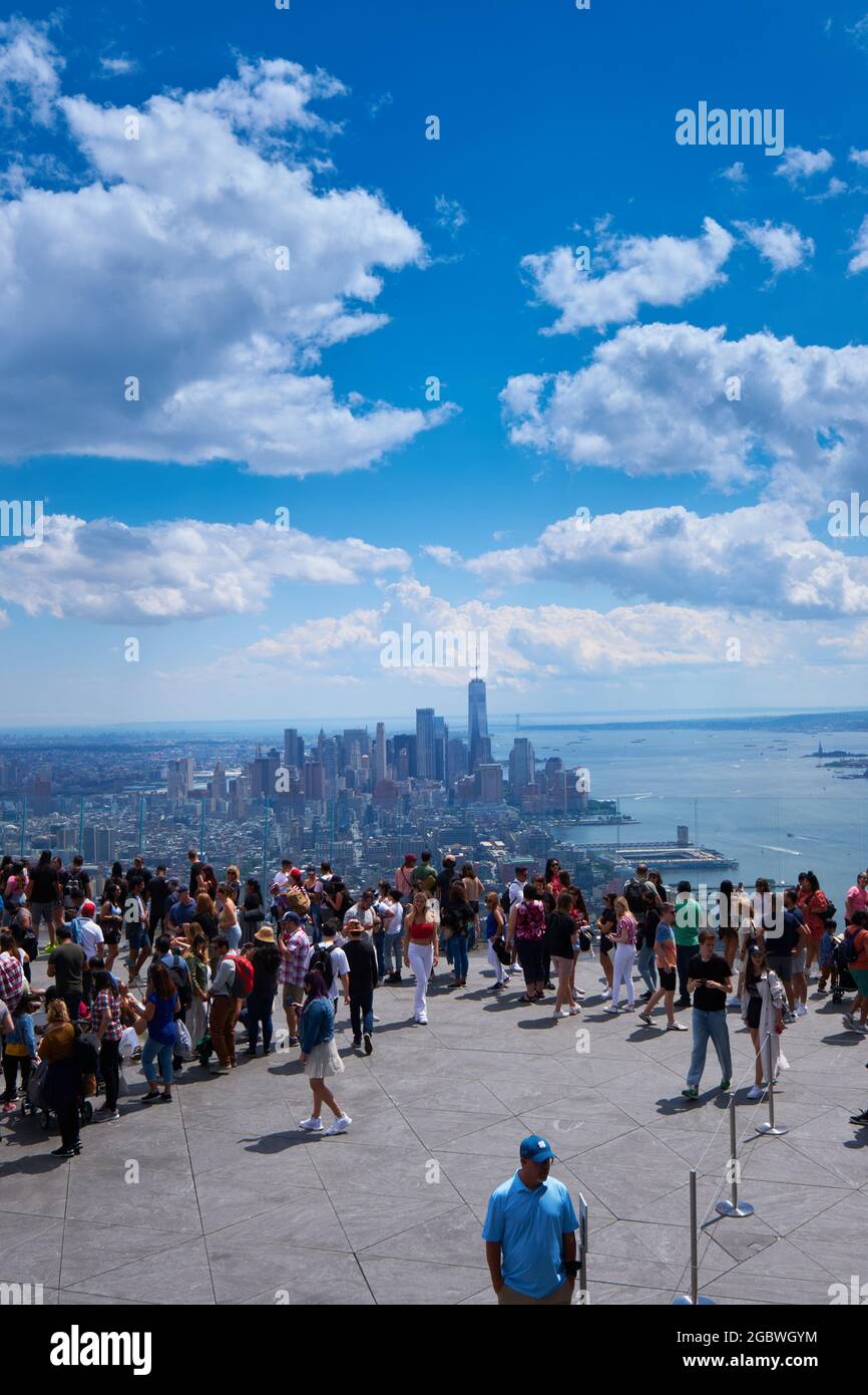 People overlook lower Manhattan from the Edge observation deck near Hudson river, New York City ...