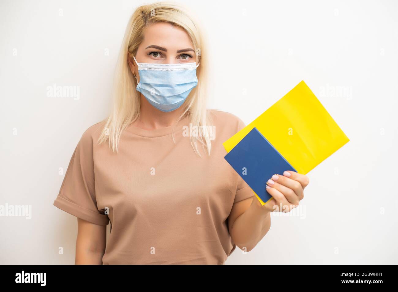 Woman with medical mask holding inernational certificate of the ...