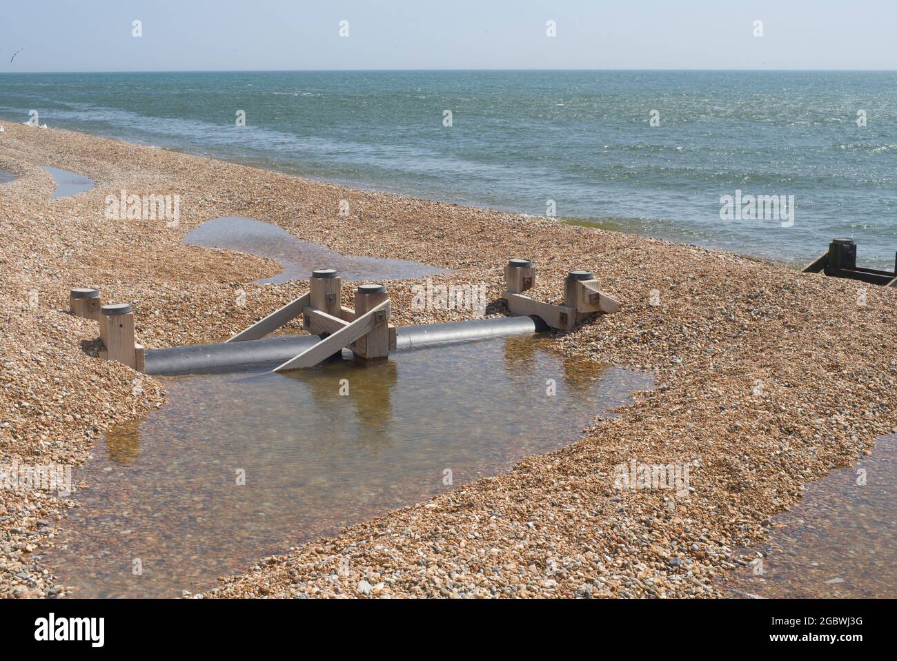 Beach drain pipe into the sea Stock Photo - Alamy
