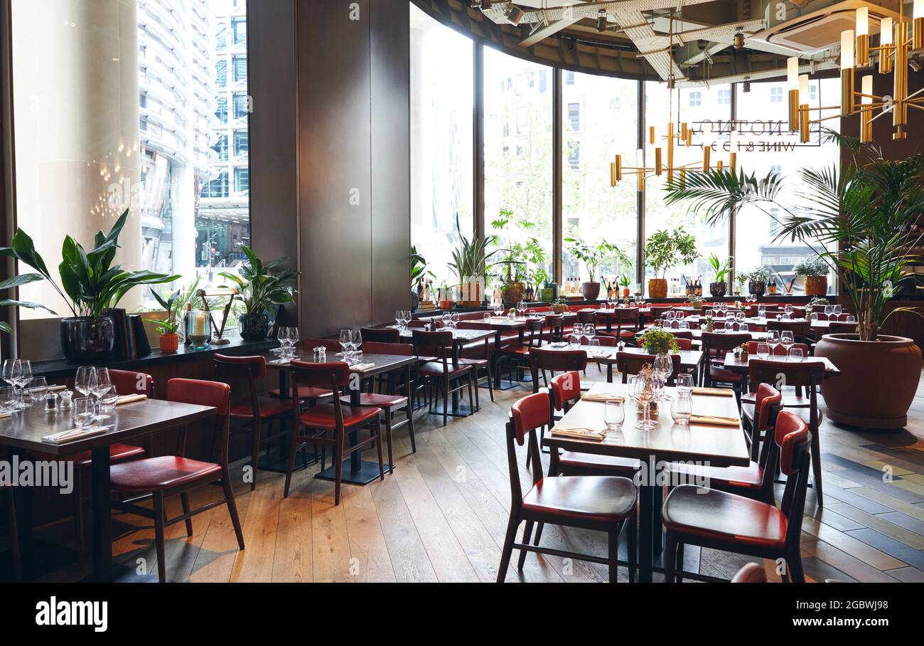 Stylish restaurant interior with set tables Stock Photo - Alamy