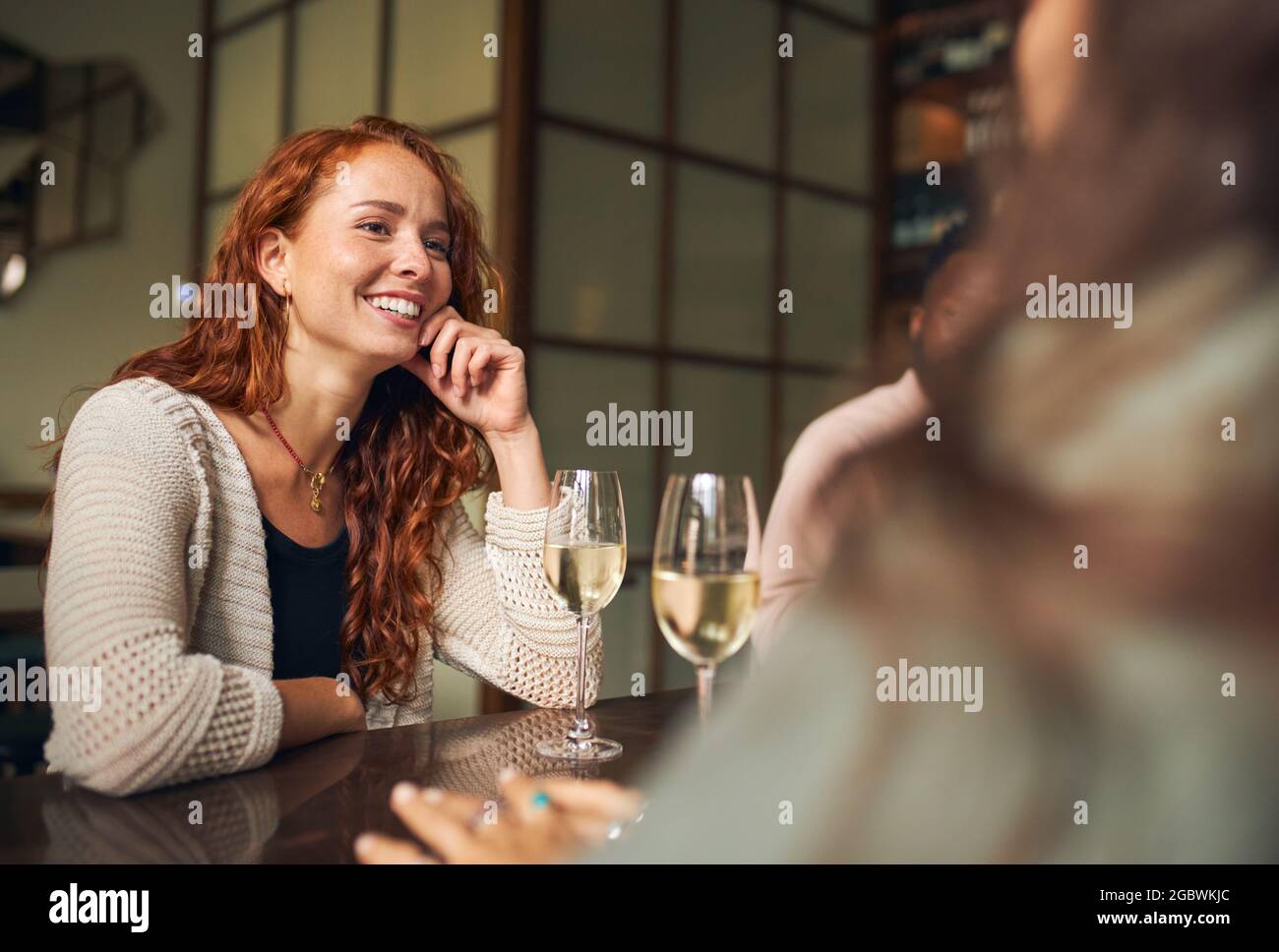 Young woman relaxing with friends in bar Stock Photo - Alamy