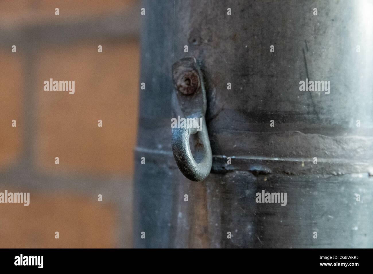 Closeup of a metal pipe with a hook attached on it with a screw Stock ...