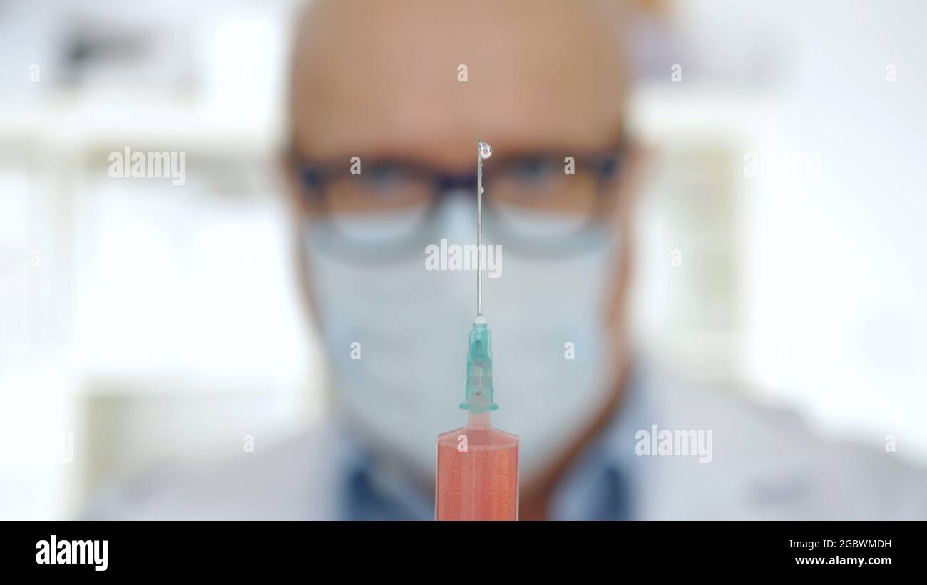 Doctor Wearing Protecting Gloves and Face Mask Keeping in Hand an ...