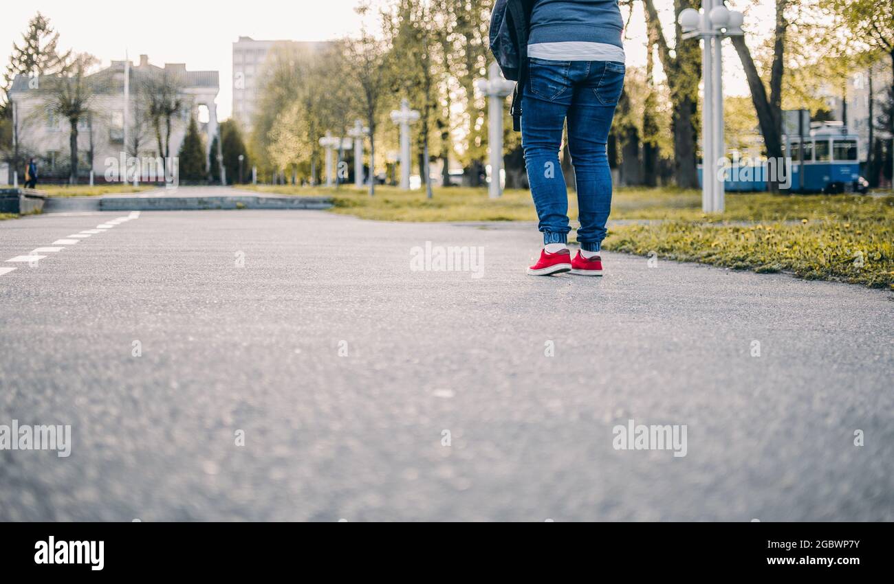 Walking man with blue jeans and red shoes in a street Stock Photo - Alamy