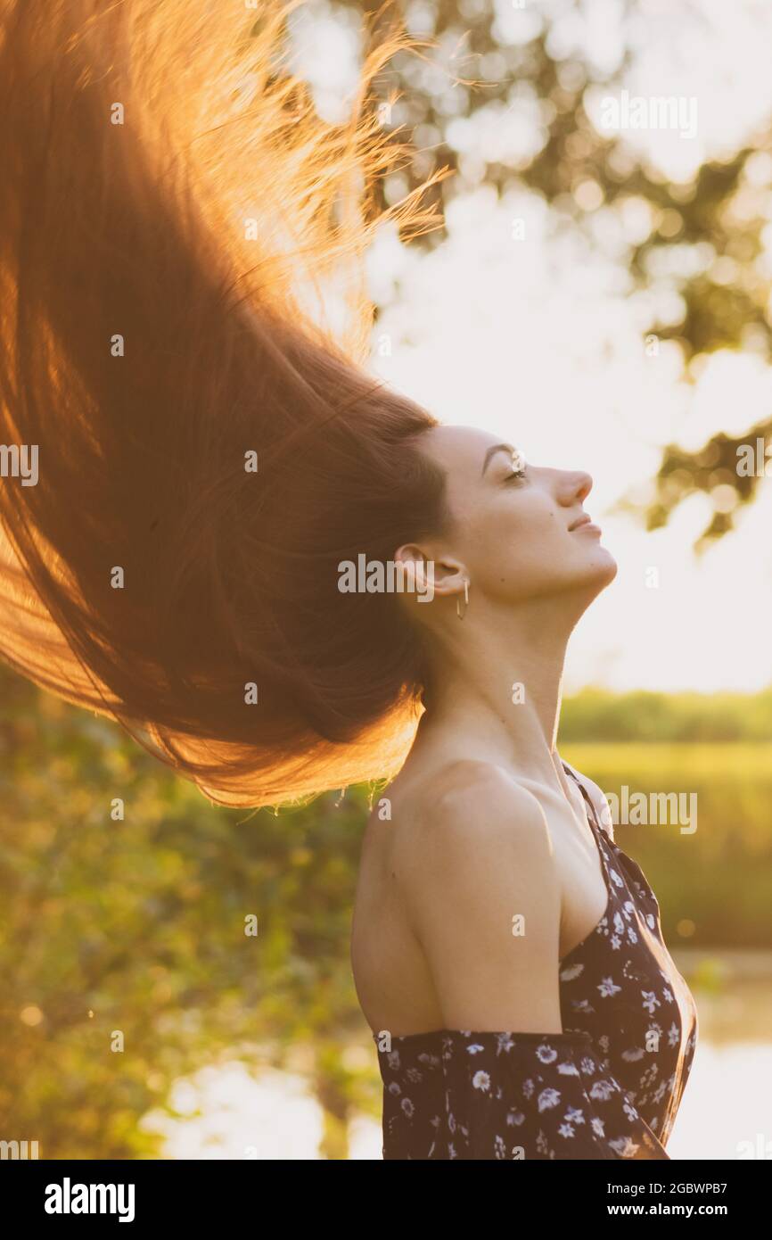 Gorgeous young brunette woman portrait with levitating hairs during ...
