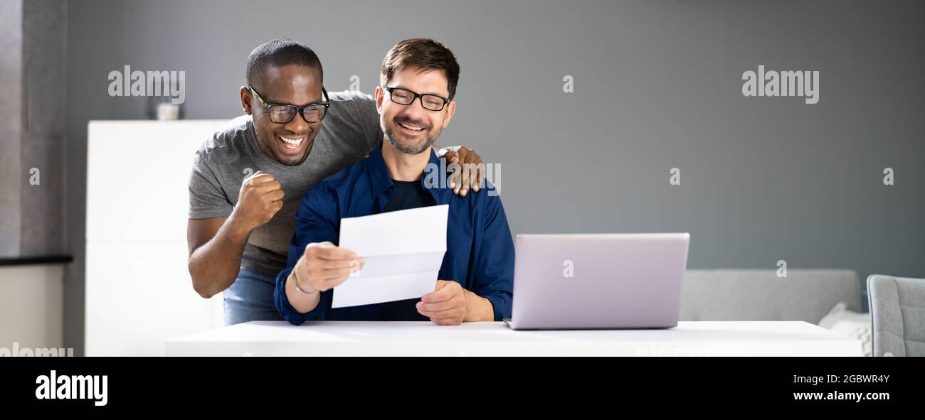 Happy Gay Couple Reading Letter Or Mail Stock Photo - Alamy