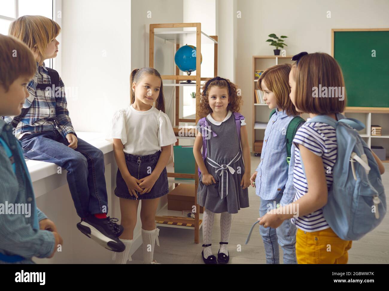 Group of shy little elementary school children meet each other for the ...