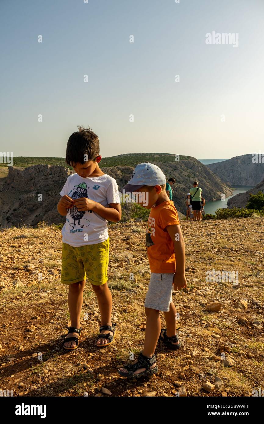 ZADAR, CROATIA - Jul 09, 2021: The two boys standing on a dry surface ...