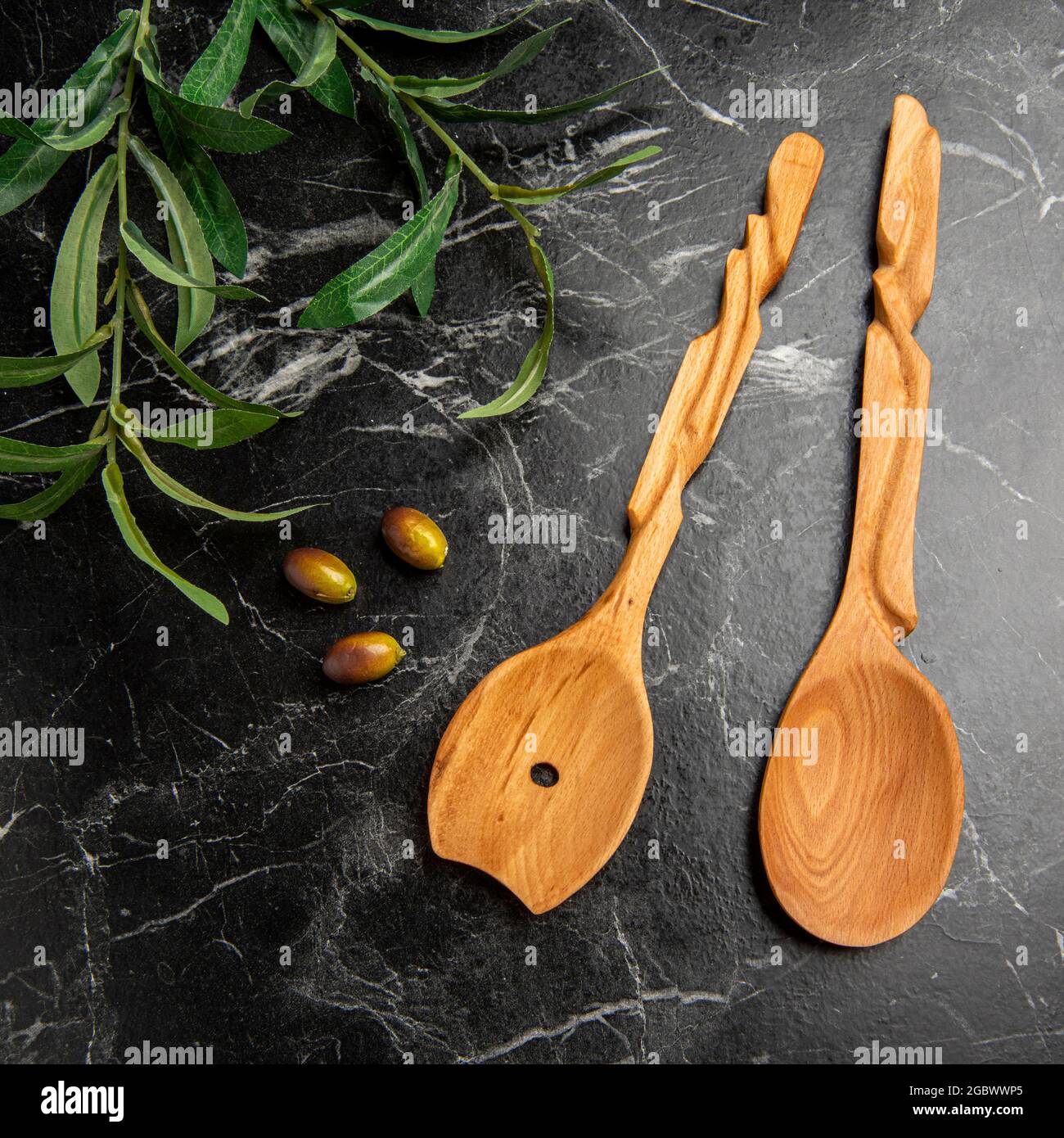 wooden spoons on the table with olives Stock Photo - Alamy