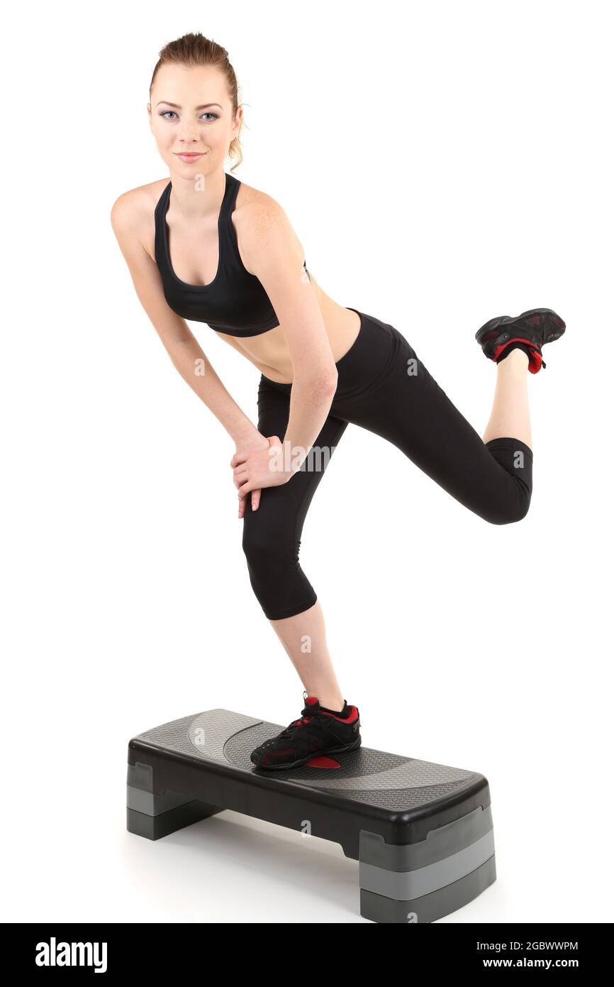 Young woman doing fitness exercises on stepper isolated on white Stock ...