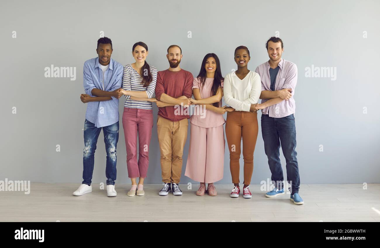 Portrait of a smiling group of diverse multiracial people standing in a ...