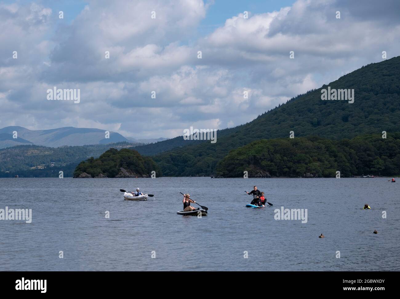 Paddle boards, canoes and swimmers take advantage of the fine ...
