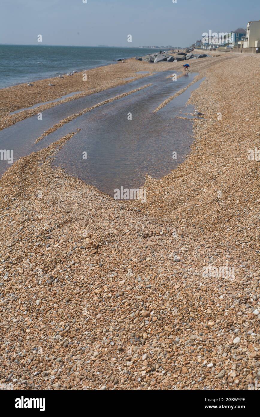 Rearranging shingle on the beach hi-res stock photography and images ...