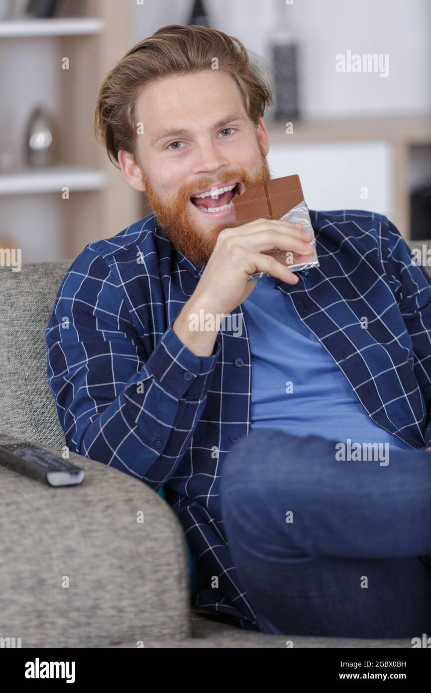 Man eats chocolate candy hi-res stock photography and images - Alamy
