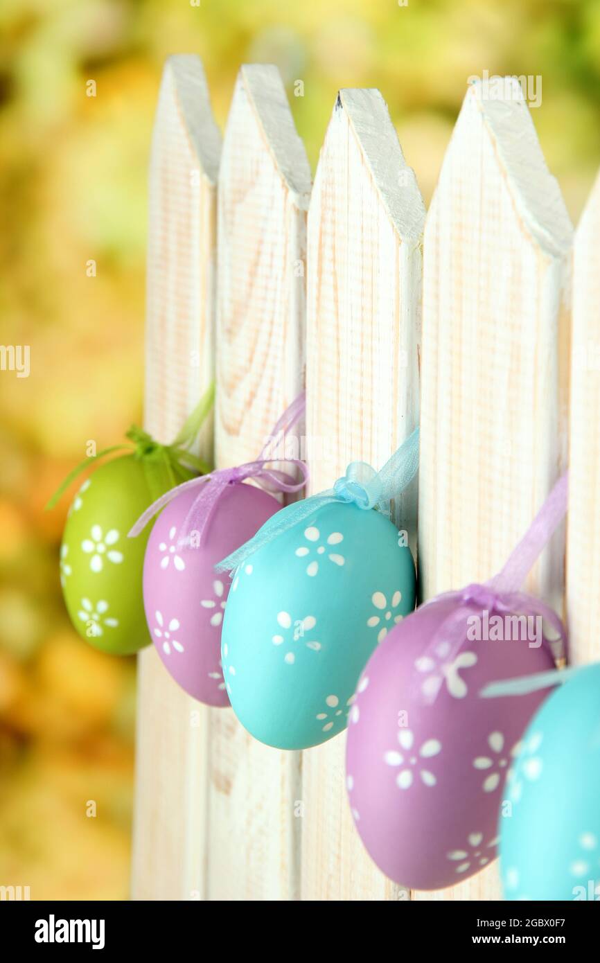 Art Easter background with eggs hanging on fence Stock Photo - Alamy