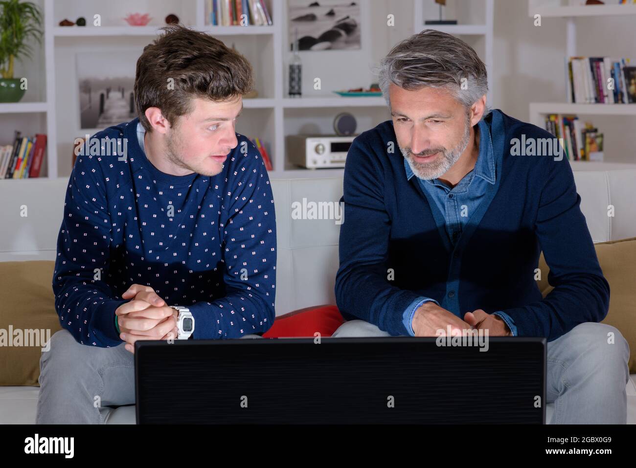 the two men watching television Stock Photo - Alamy