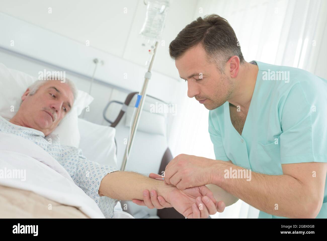 Doctor prepares patient injection hi-res stock photography and images ...