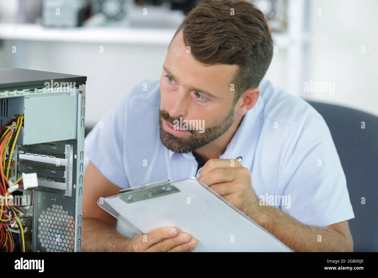 a computer engineer with motherboard diagnostics Stock Photo - Alamy