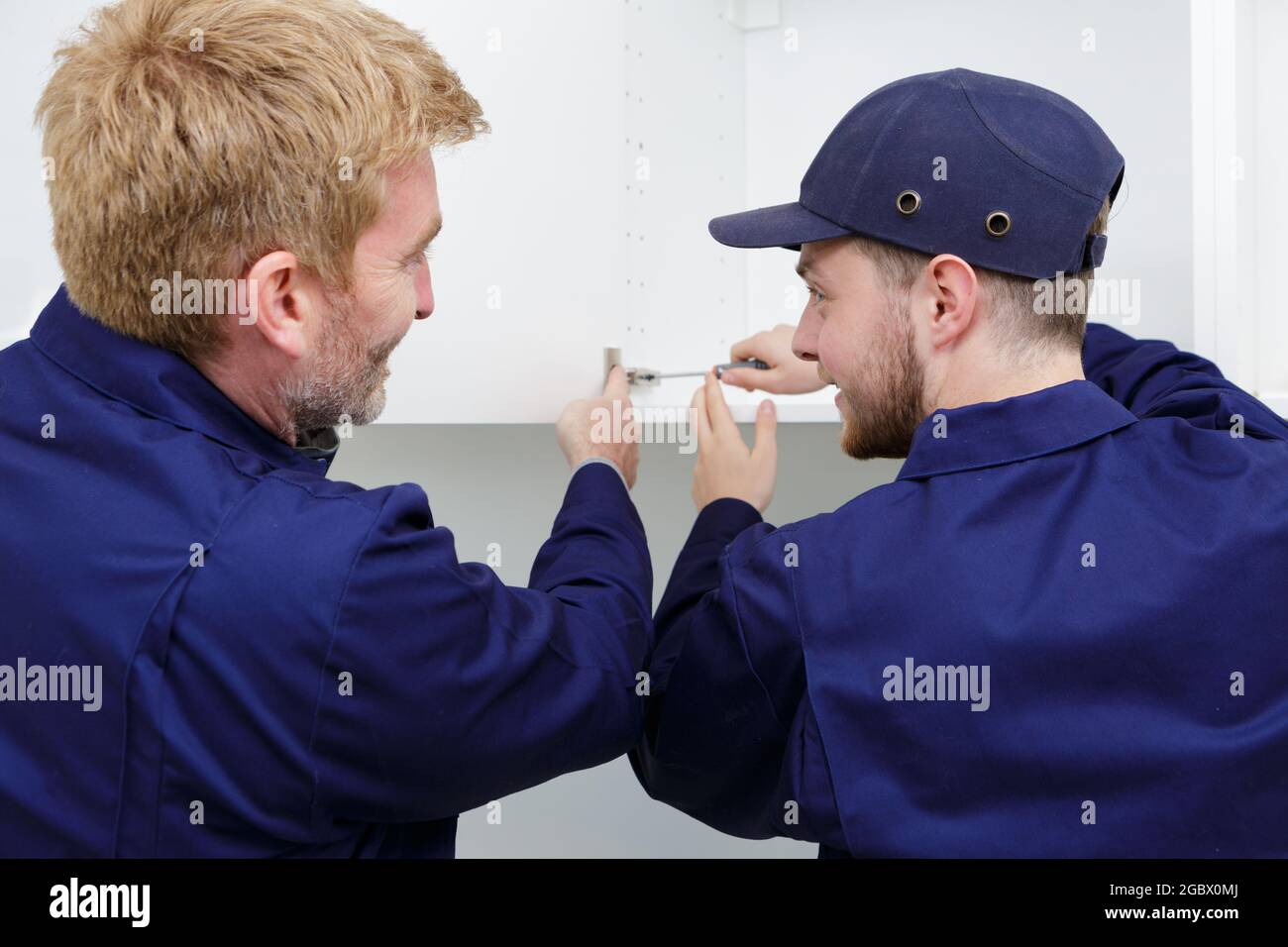 wardrobe joiners at installation work Stock Photo - Alamy