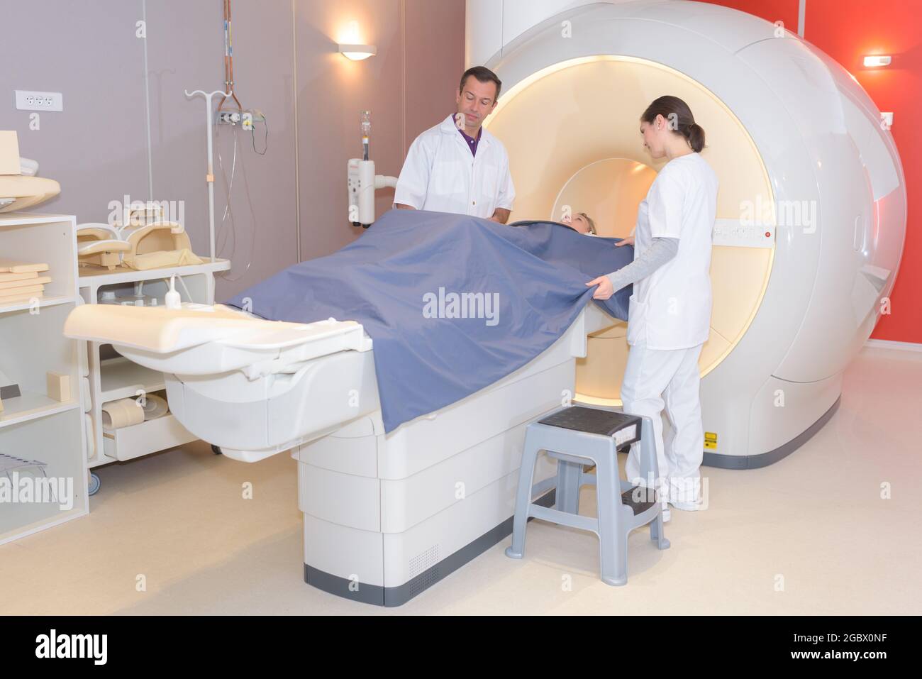 two doctors preparing patient to ct scan procedure Stock Photo - Alamy