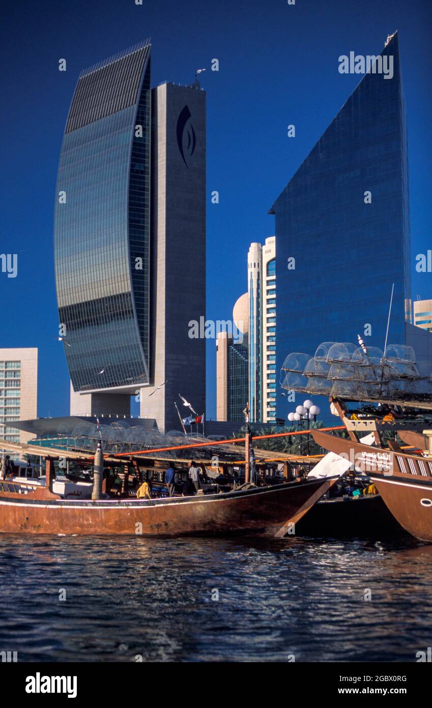 Cargo ships and Emirates NBD headquarters building in Deira, Abra boat ...
