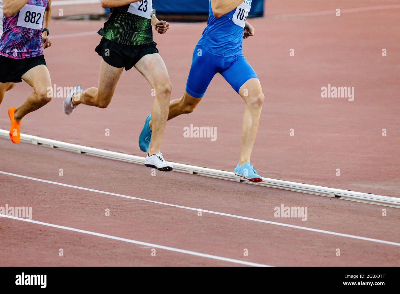 group male runners run middle distance race at stadium Stock Photo - Alamy