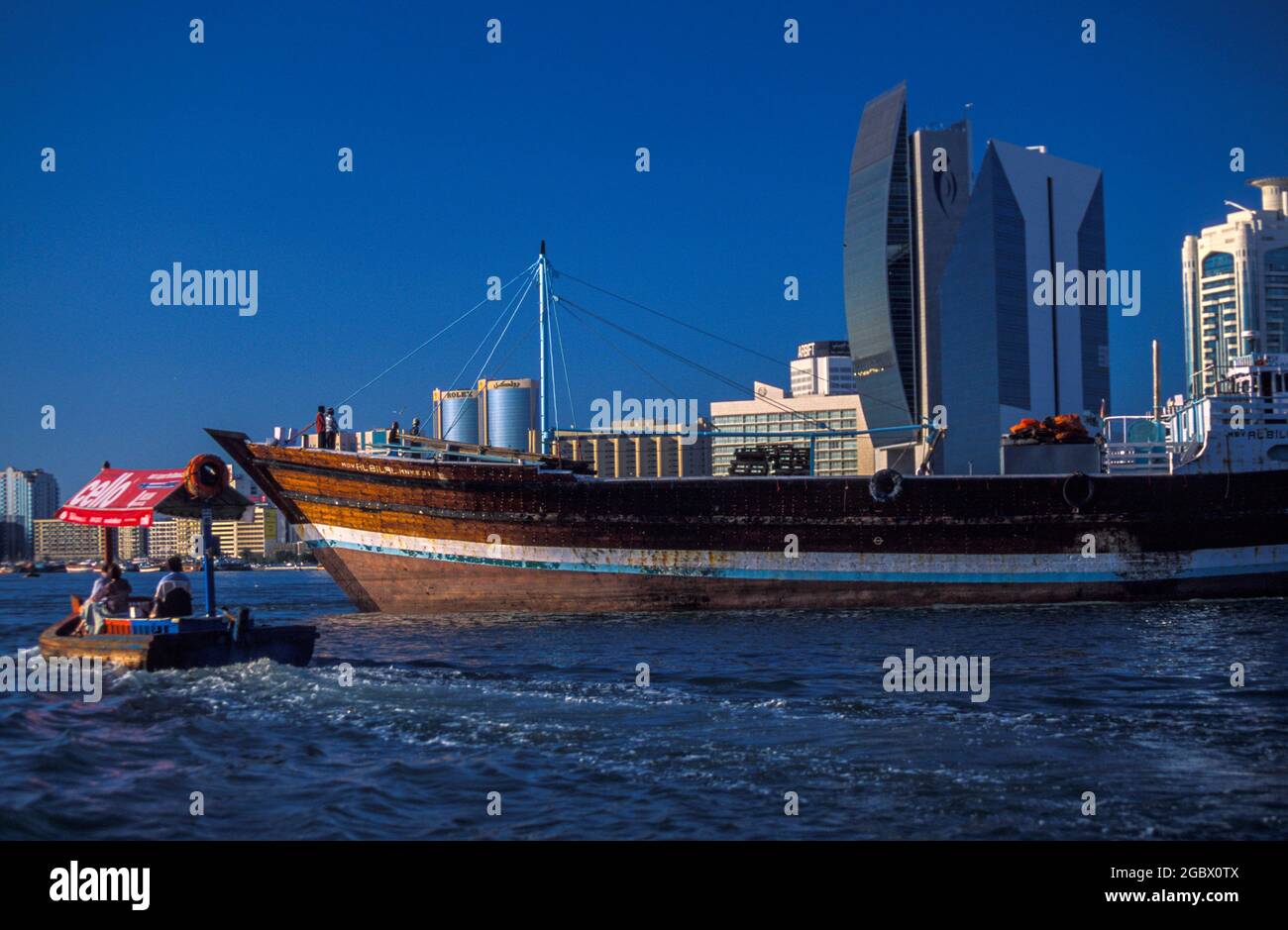 Abra boat a a cargo ship with the Emirates NBD headquarters building in ...