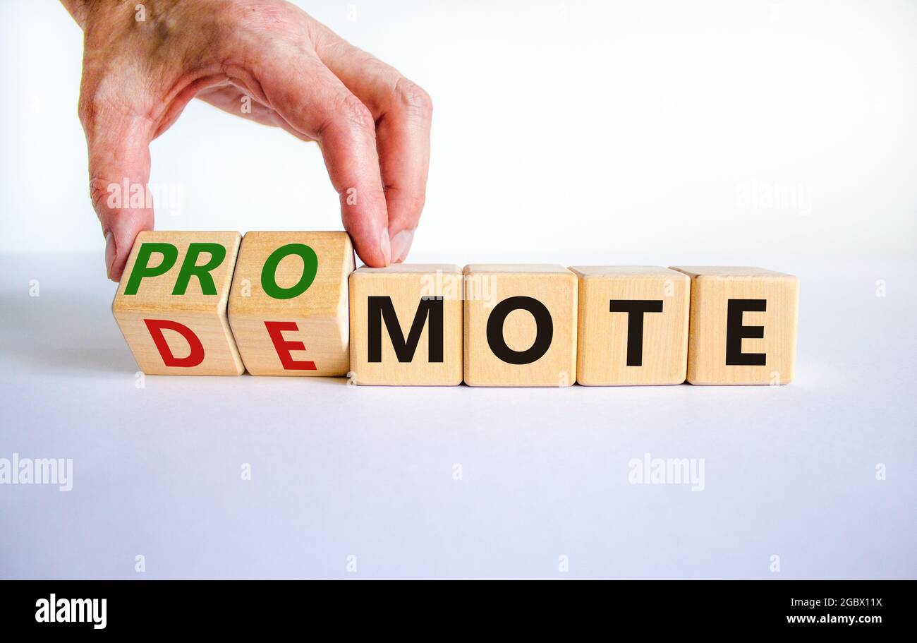 Promote or demote symbol. Businessman turns cubes and changes the word ...