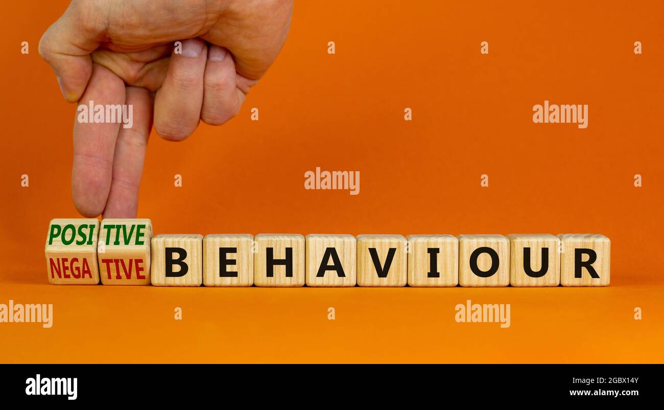 Positive or negative behaviour symbol. Businessman turns cubes, changes ...