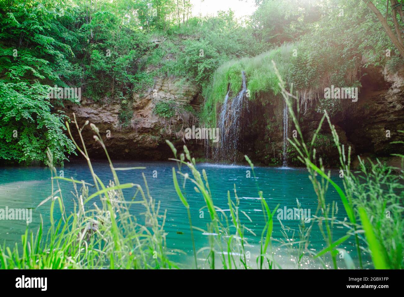 small beautiful waterfall with blue lake copy space Stock Photo - Alamy