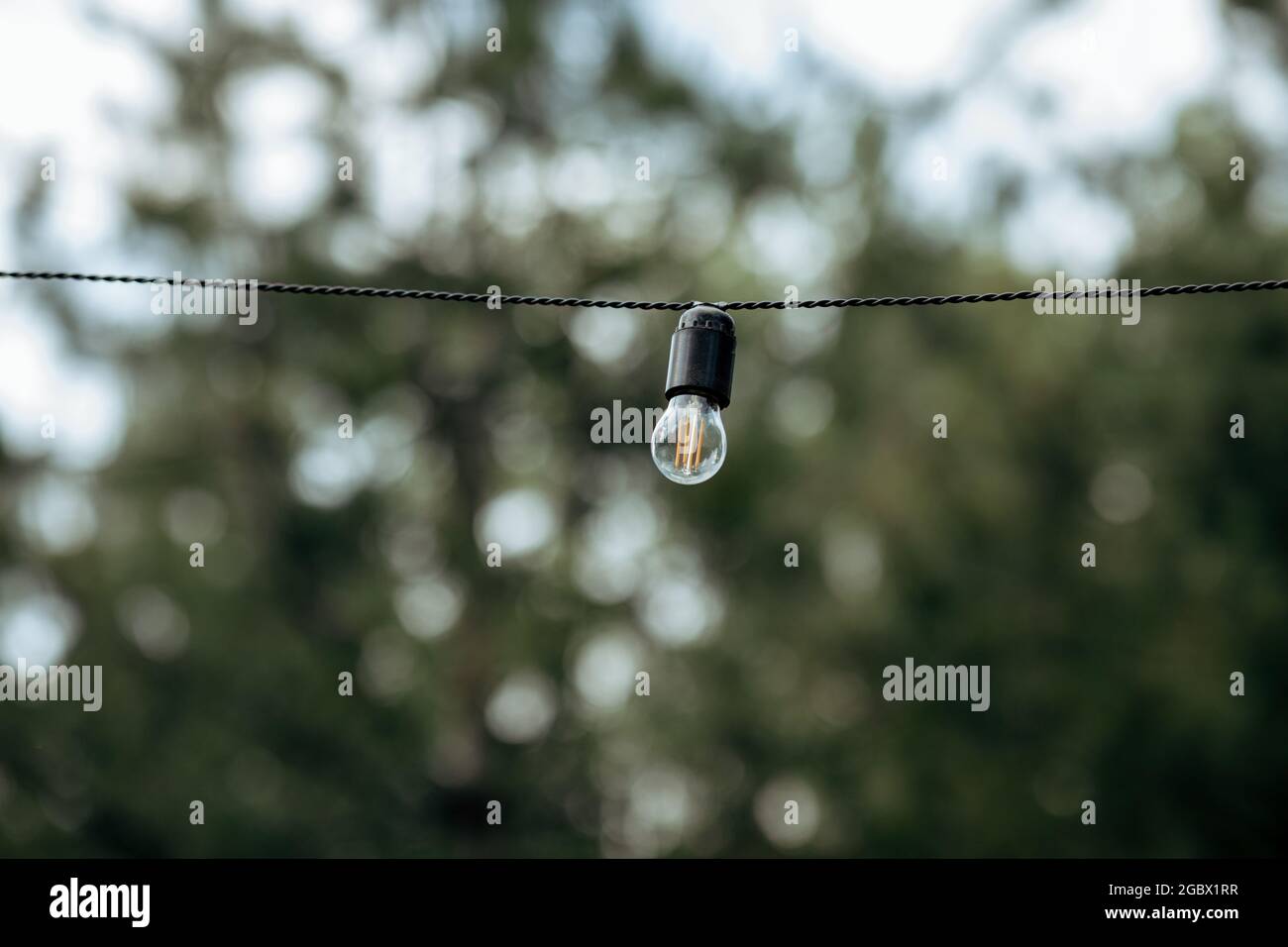 Row of light bulbs hanging hi-res stock photography and images - Alamy