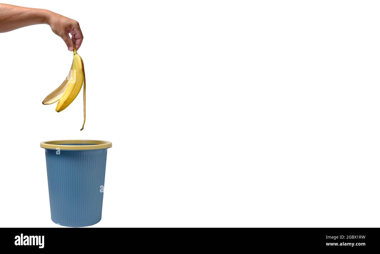 In a man hand, banana peel is thrown into trash.Food waste Stock Photo ...