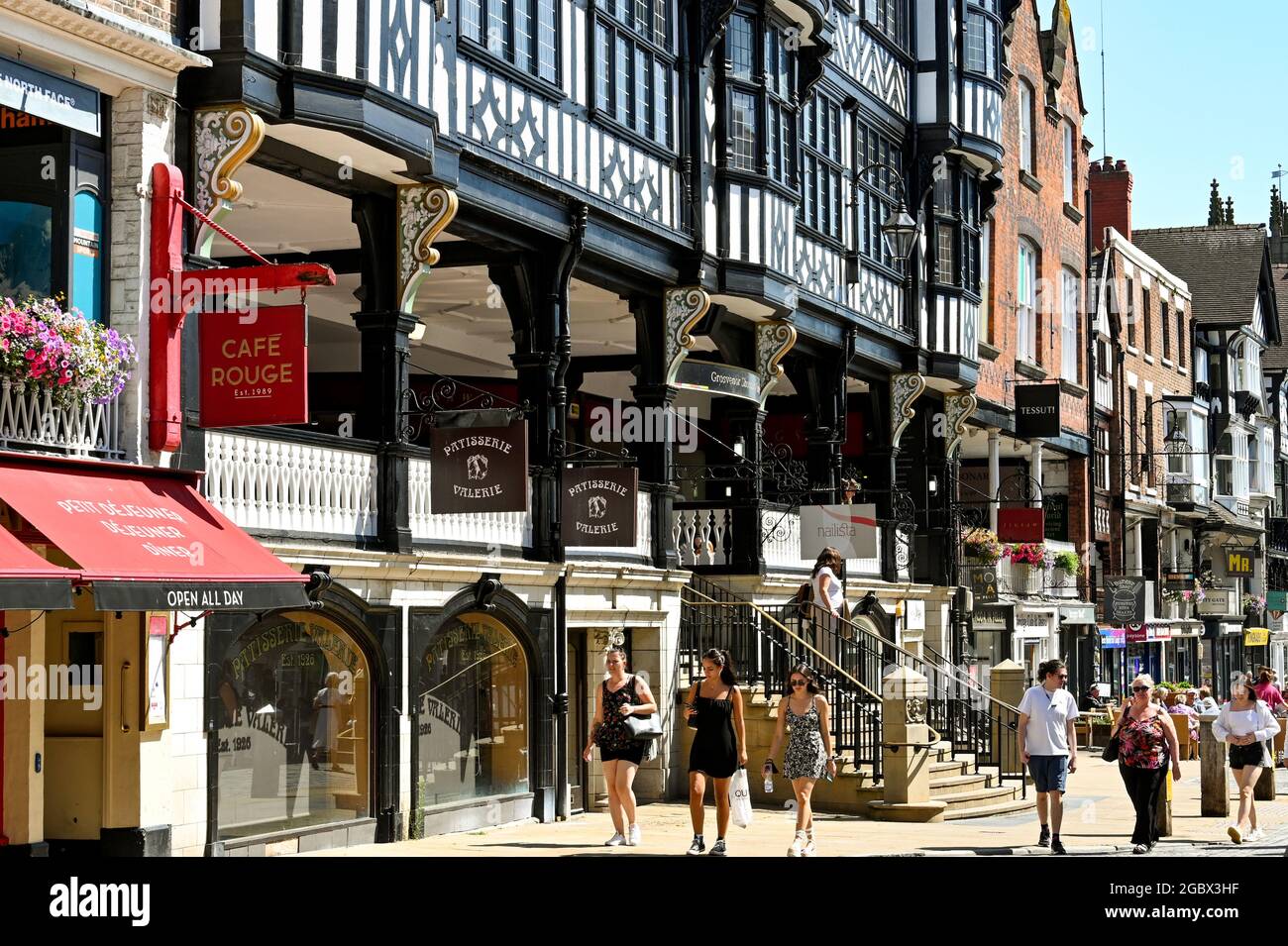 Chester, England - July 2021: People walking past the steps up to the ...