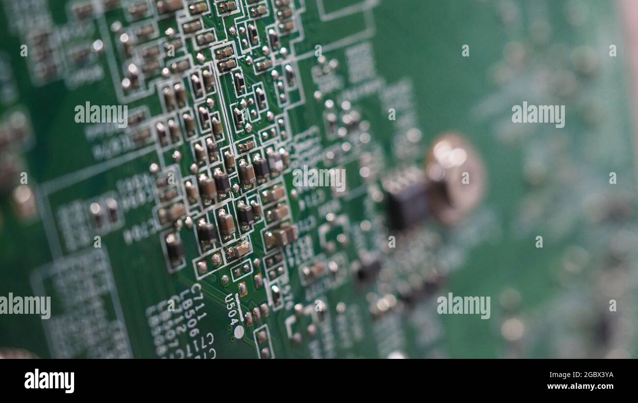 Semiconductor. cpu chip located on the green motherboard of the ...