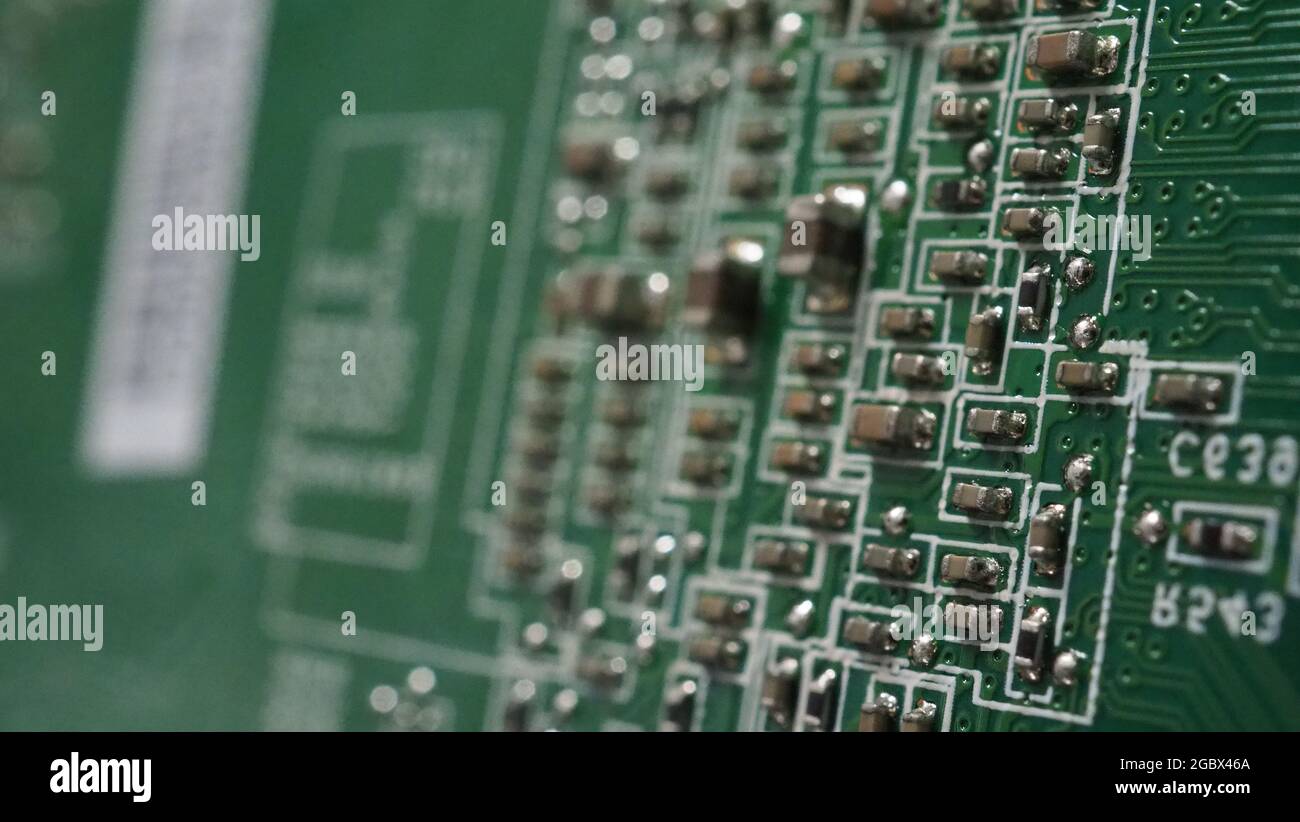 Semiconductor. cpu chip located on the green motherboard of the ...