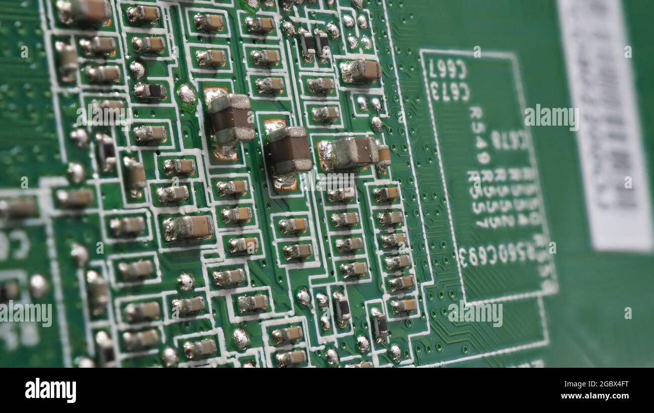 Semiconductor. cpu chip located on the green motherboard of the ...