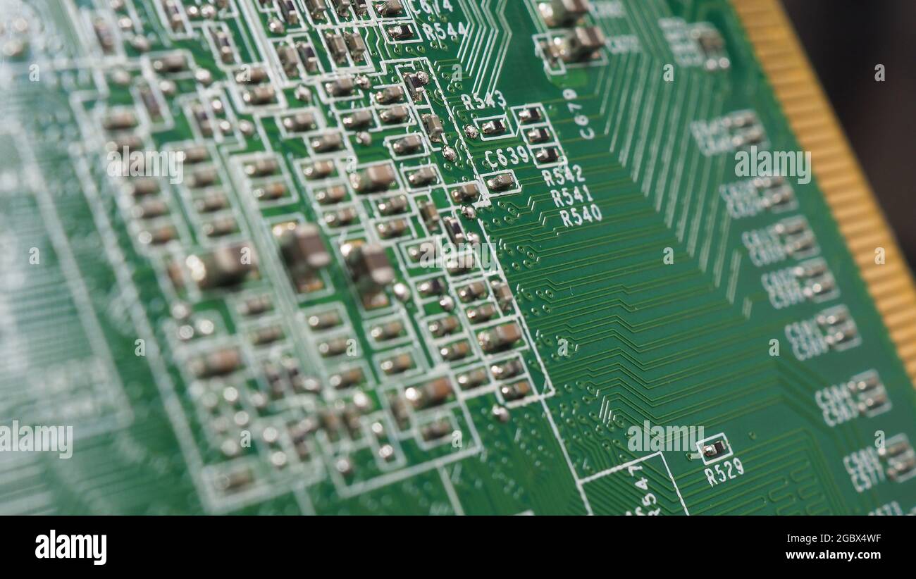 Semiconductor. cpu chip located on the green motherboard of the ...