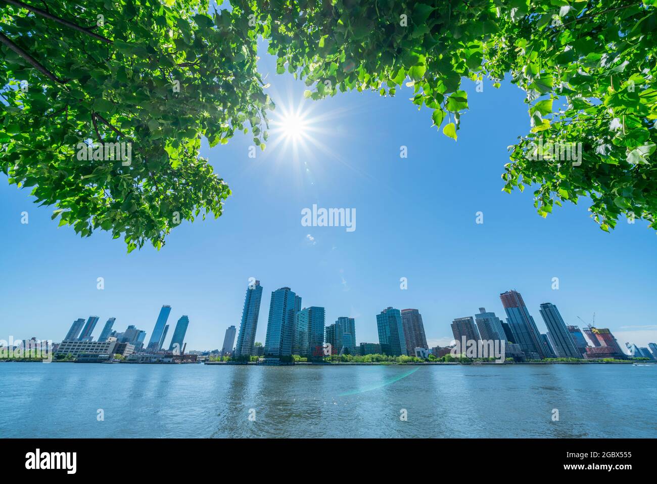 High-rise residential buildings stand beyond the East River in Long ...