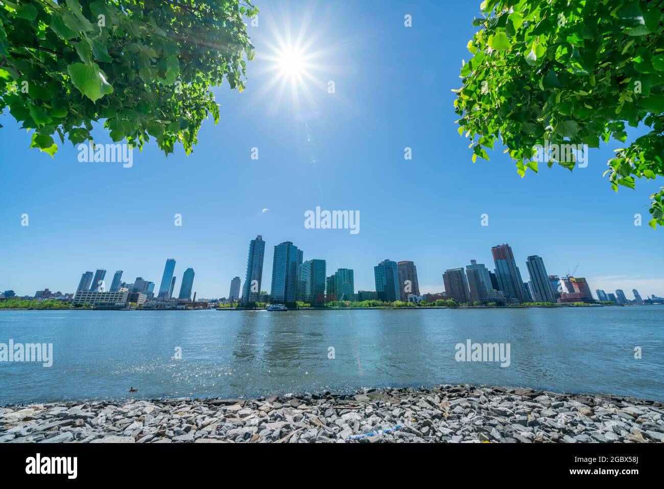 High-rise residential buildings stand beyond the East River in Long ...
