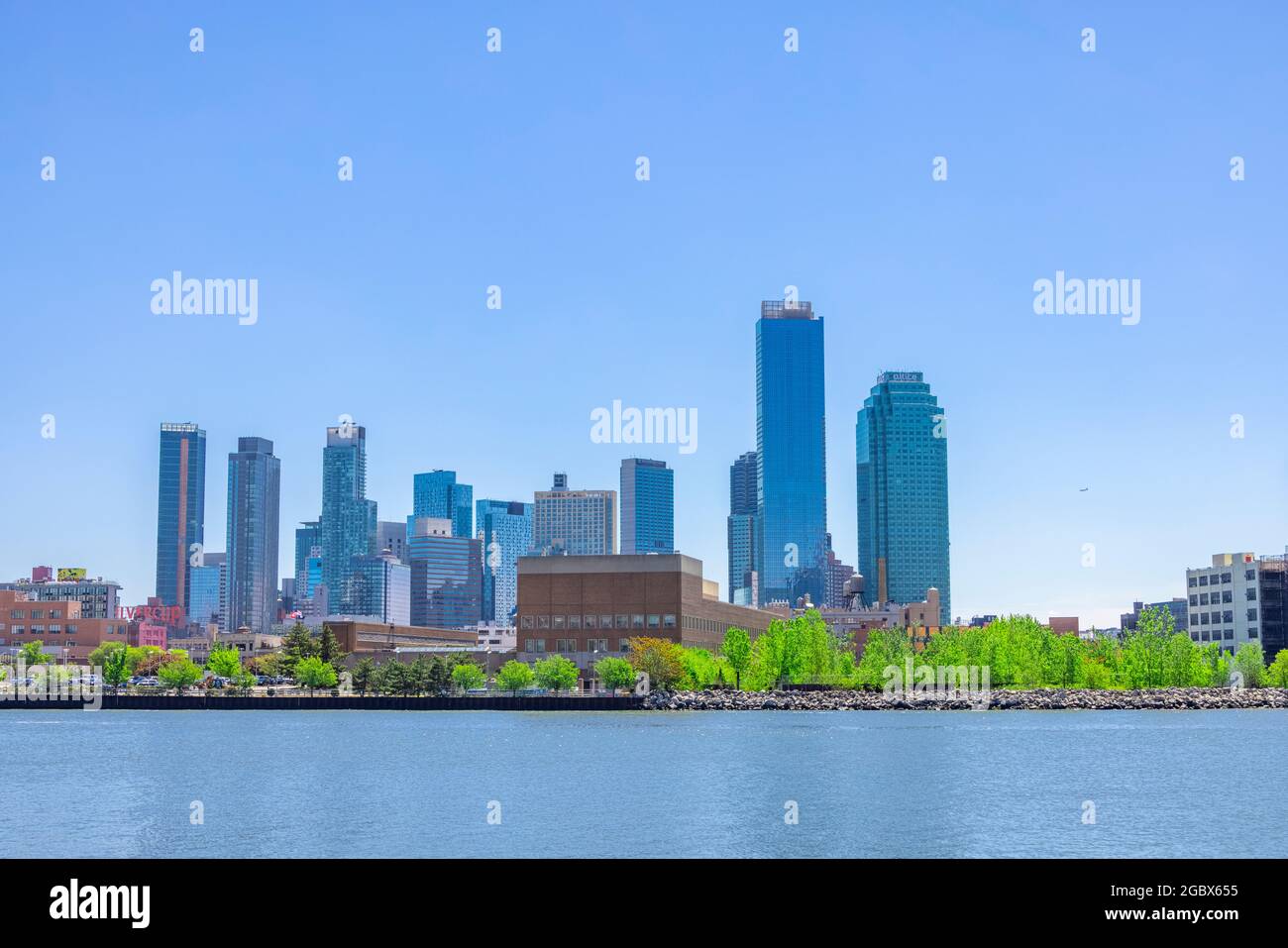 High-rise residential buildings stand beyond the East River in Long ...
