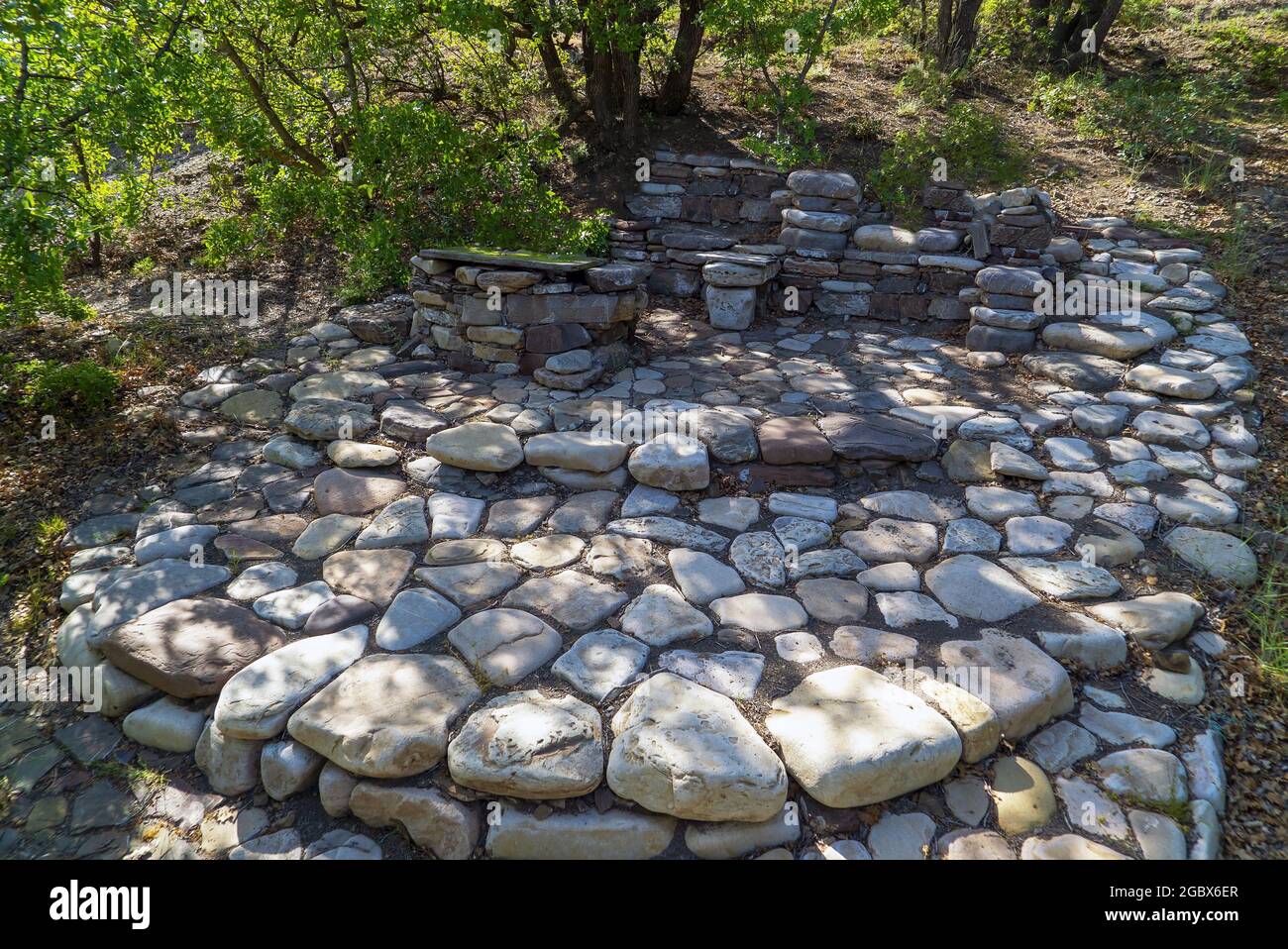 A platform made of flat sea stones in the shade of trees Stock Photo ...