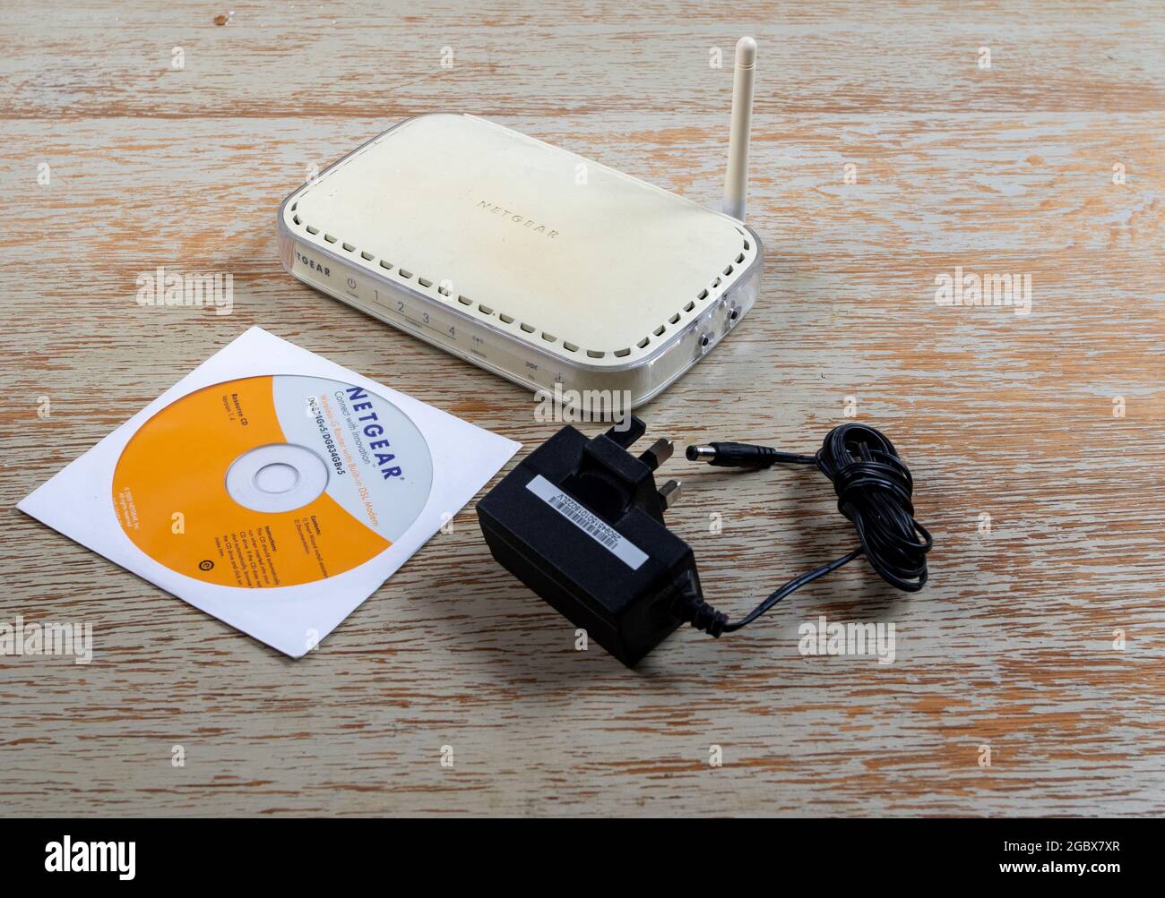 Netgear DG384G router with power supply and manual on CD Stock Photo ...