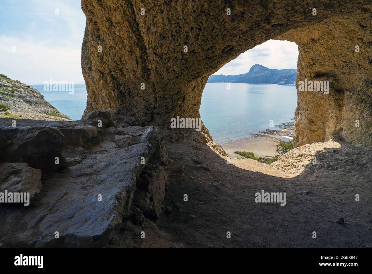 Sea view from a small cave on the slope of the coastal mountain Aeolian ...