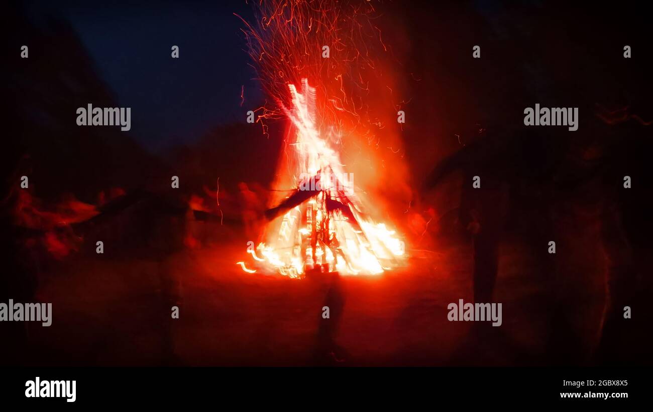 blurred background. Element of fire, huge night fire on holiday. Dance ...