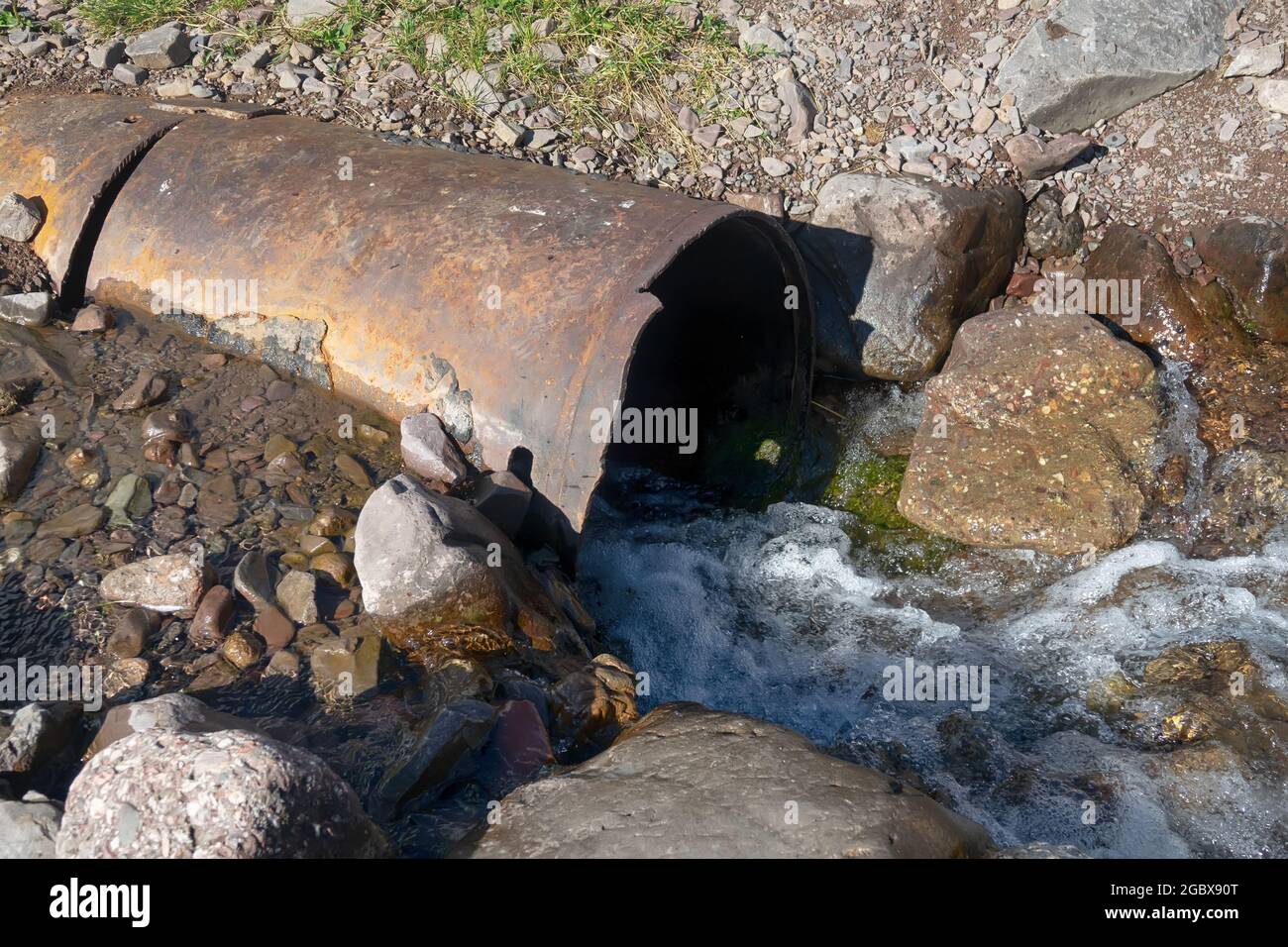 Road culvert was washed away by the spring waters of the stream Stock ...