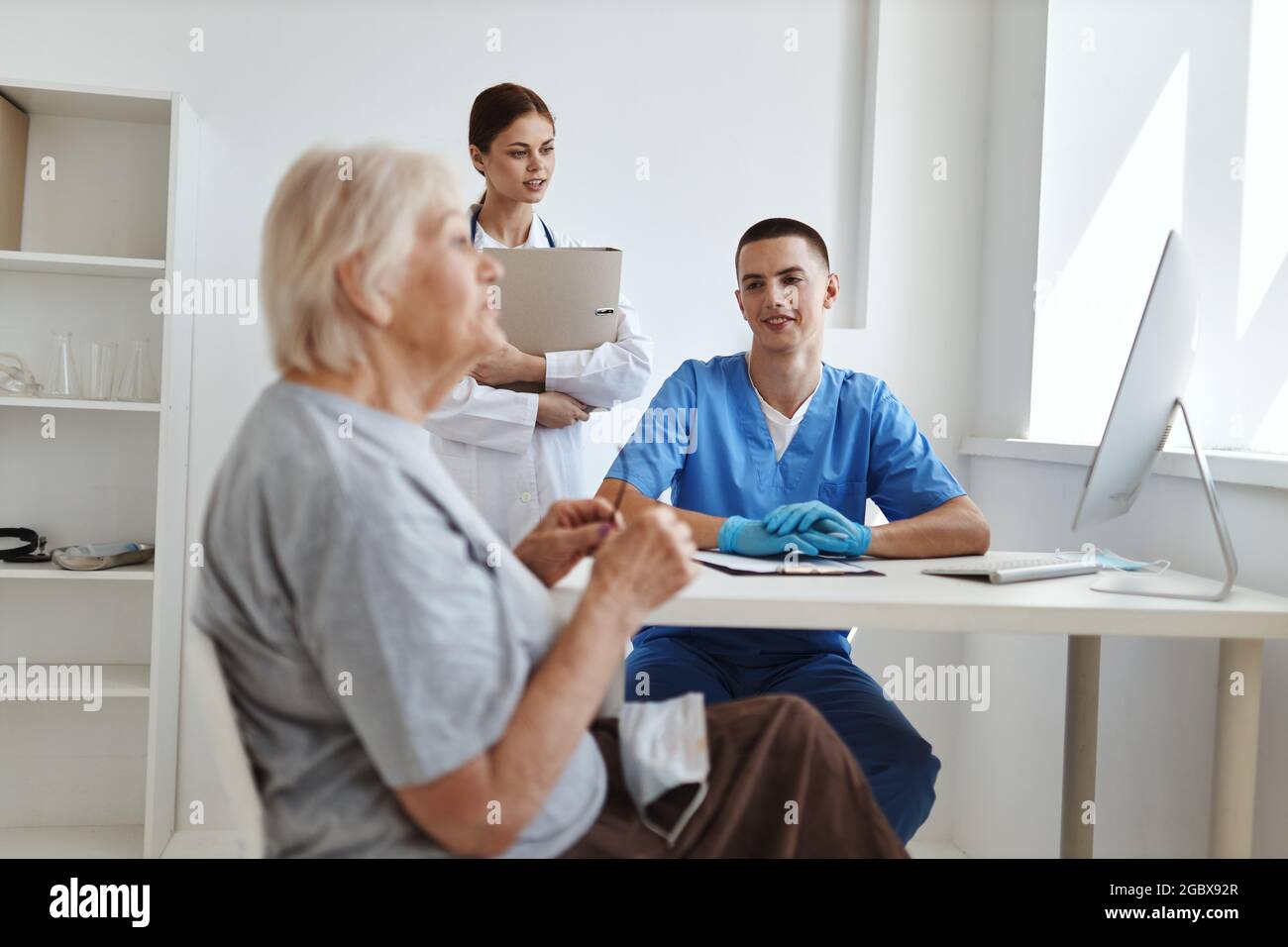 female patient communicates with doctor and nurse assistant Stock Photo ...
