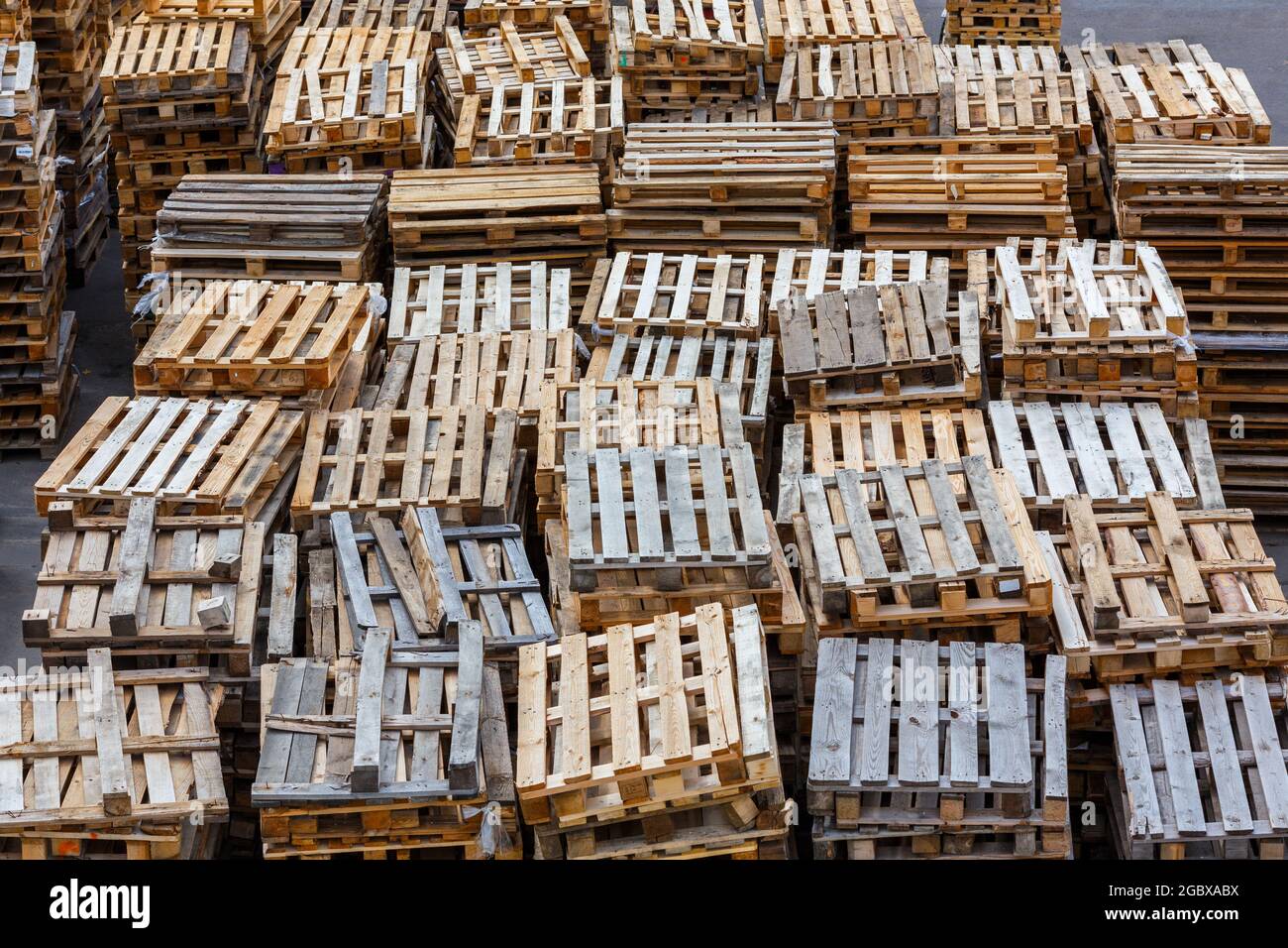 full frame background of used wooden pallet stacks - perspective view ...