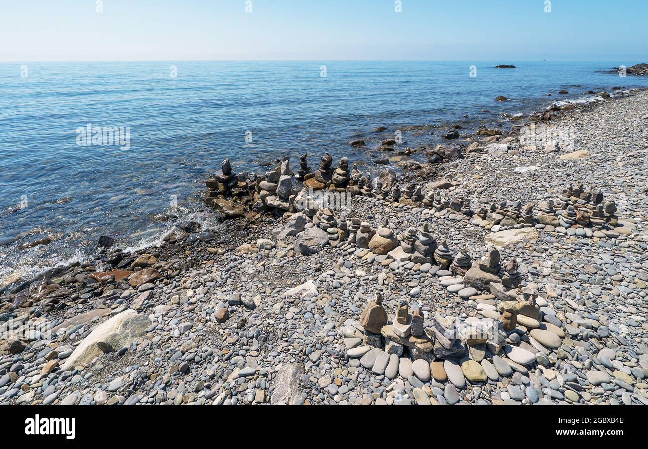 Pyramids of sea stones on the seashore .Entrance to the sea Stock Photo ...