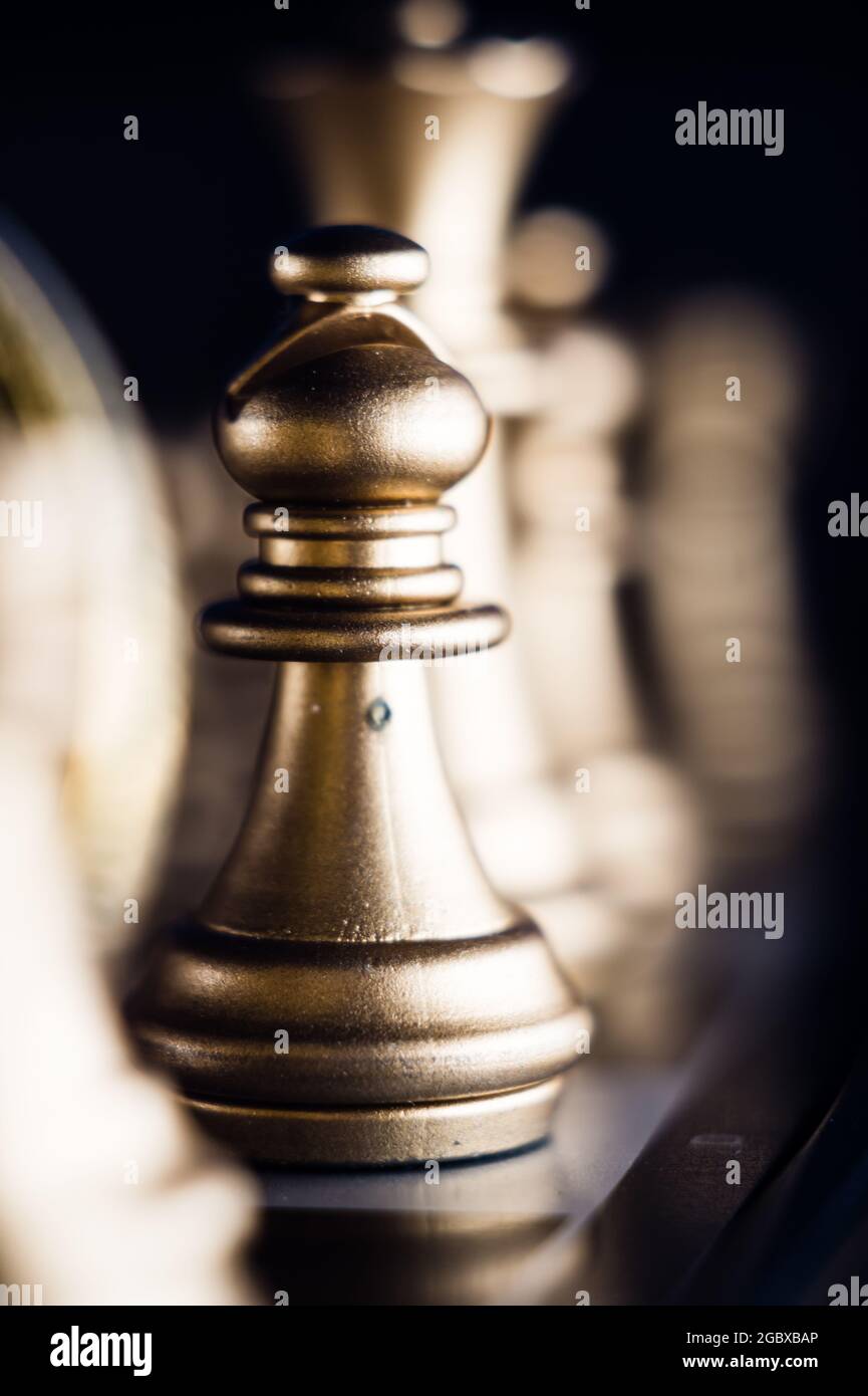 Vertical shot of golden chess pieces on a chessboard Stock Photo - Alamy