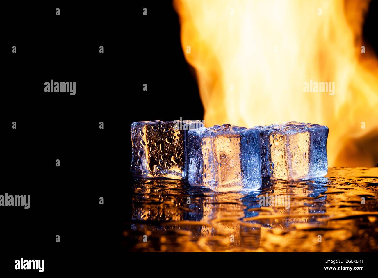 three ice cubes against the background of fire, concept Stock Photo - Alamy